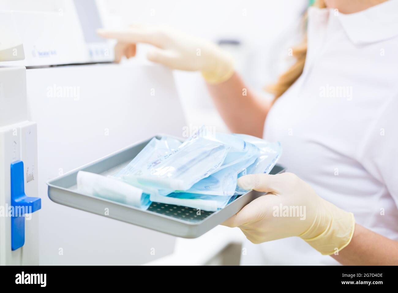 Assistant with sterile dentist tools Stock Photo - Alamy