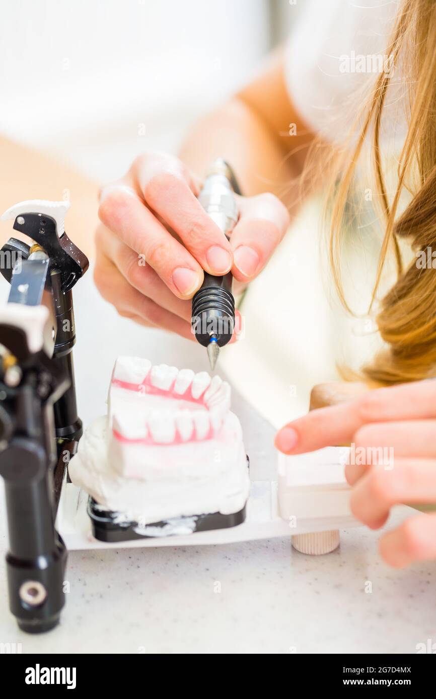 Dental technician producing denture Stock Photo - Alamy