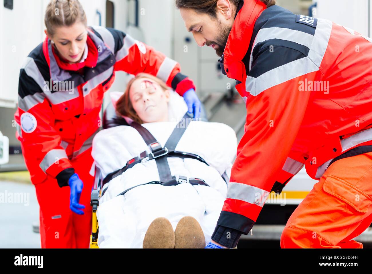 Emergency doctor and nurse or ambulance team transporting accident ...