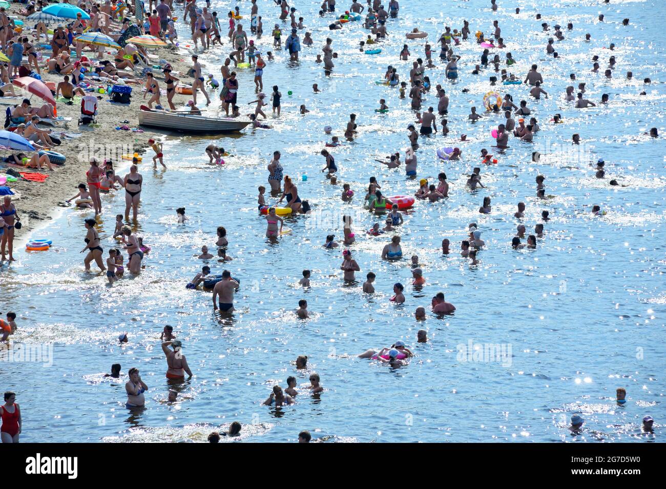 Beach, crowd of people sunbathing and swimming in the water. Hydropark ...