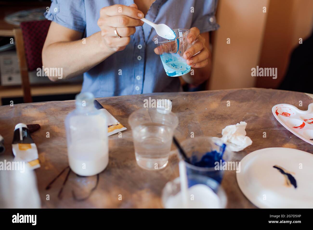 artist working on creating picture in her art studio. Interior painting ...