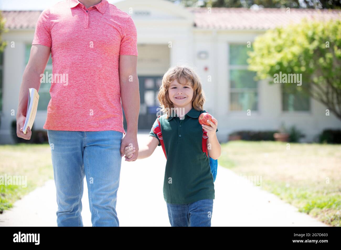 childhood and parenthood. cropped parent leads child boy in first grade ...