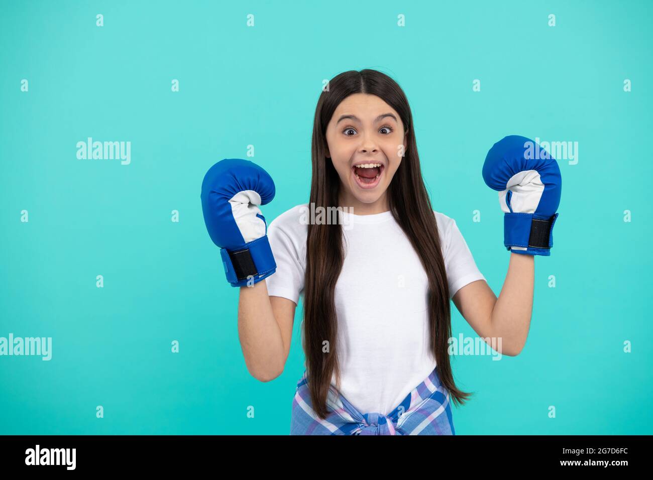 happy child boxer celebrate success in boxing gloves during sport ...
