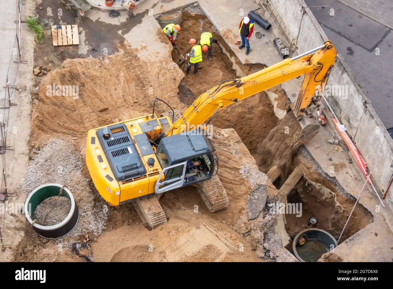 Excavator at a construction site while digging trenches for calcining ...