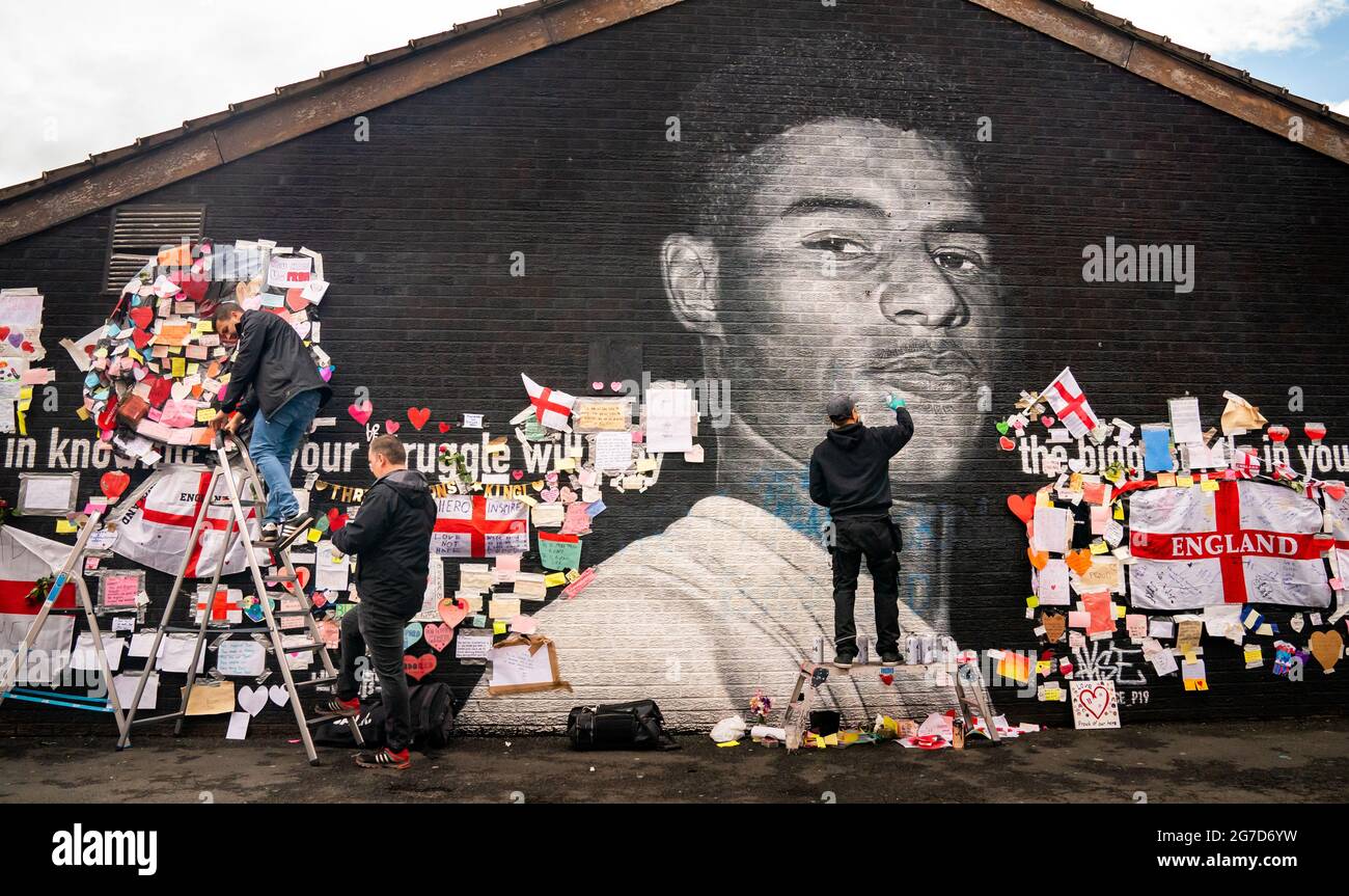 Street artist Akse P19 repairs the mural of Manchester United striker ...