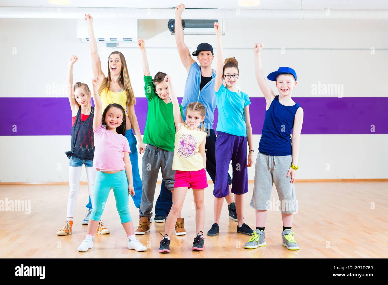 Dance teacher giving children Zumba fitness class in gym Stock Photo ...