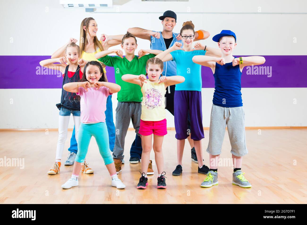 Dance teacher giving children Zumba fitness class in gym Stock Photo ...