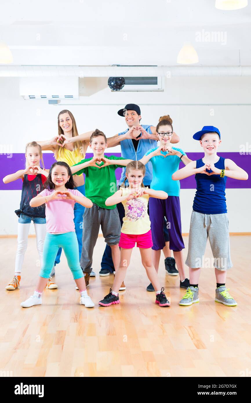 Dance teacher giving children Zumba fitness class in gym Stock Photo ...