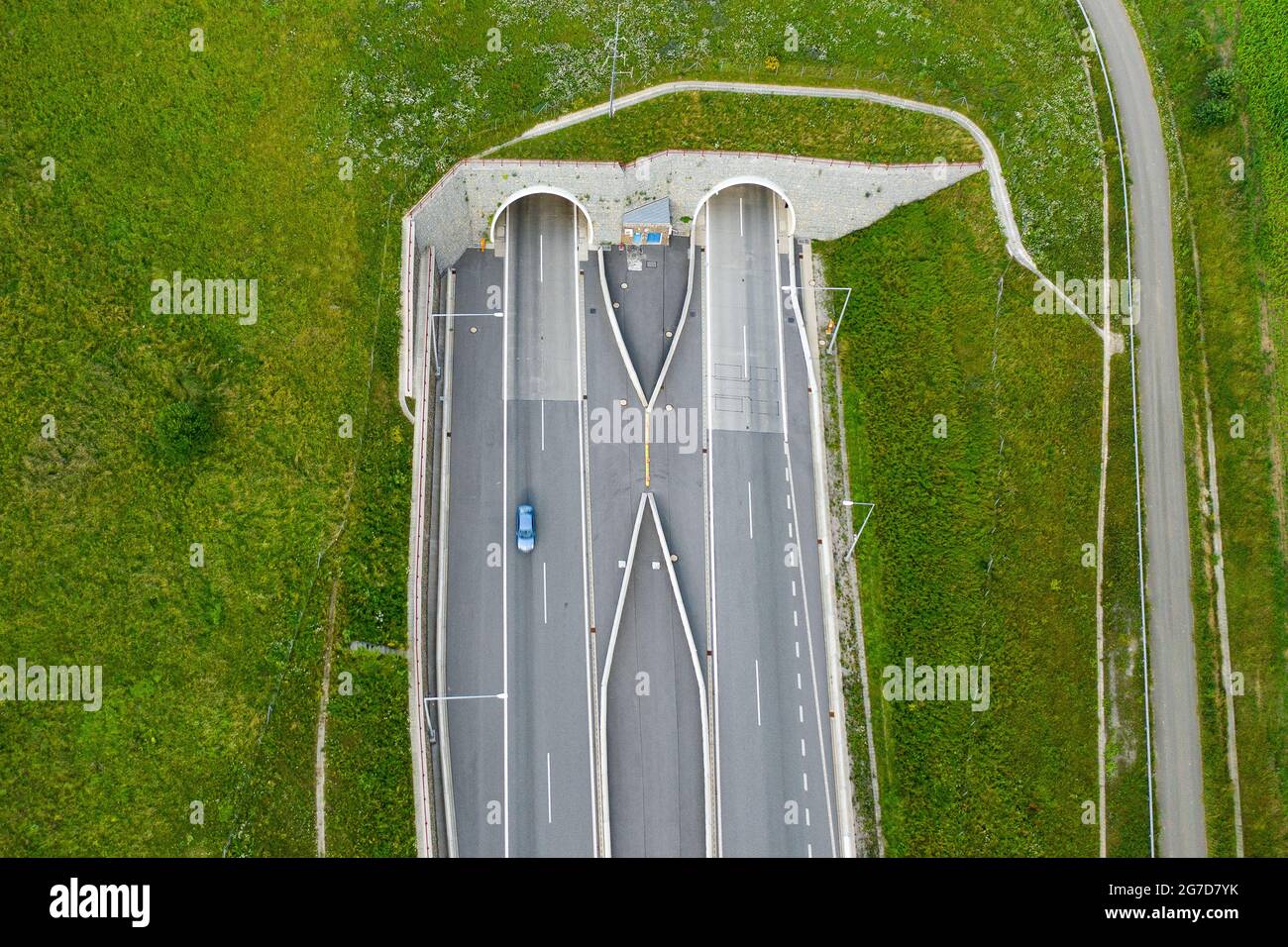 Top view on the tunnel entrance of highway covered with green grass ...