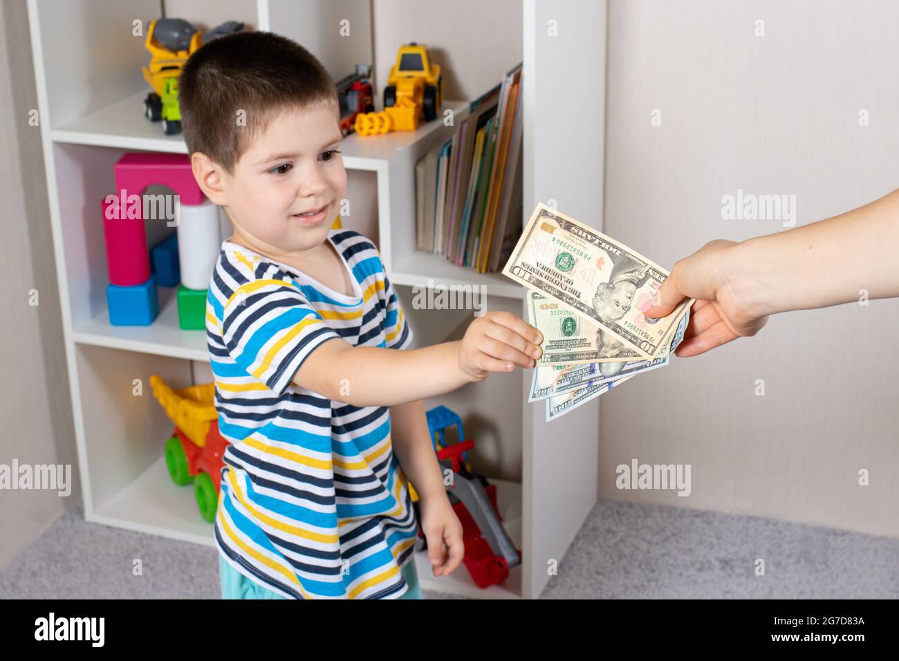 Money in the hands of a child hi-res stock photography and images - Alamy