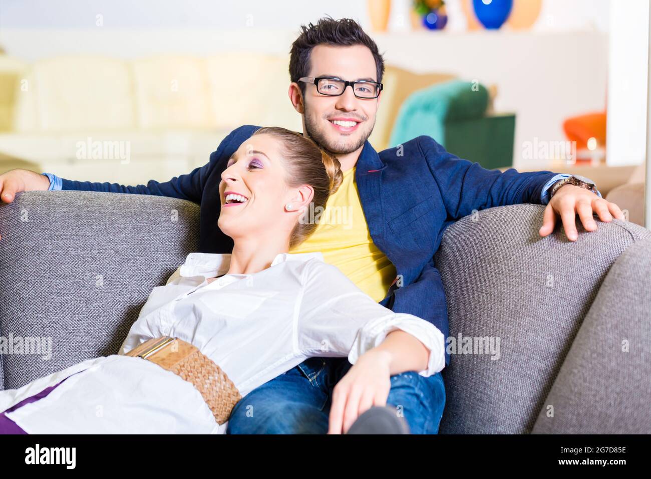 Young couple selecting together sofa hi-res stock photography and ...