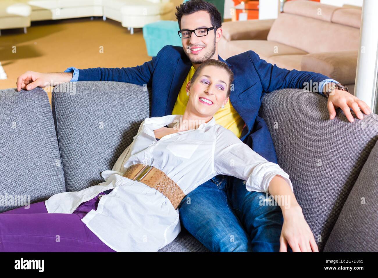 Young couple selecting together sofa hi-res stock photography and ...