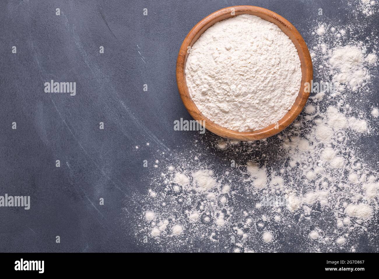 Baking or cooking background, flour on the dark background. Top view ...