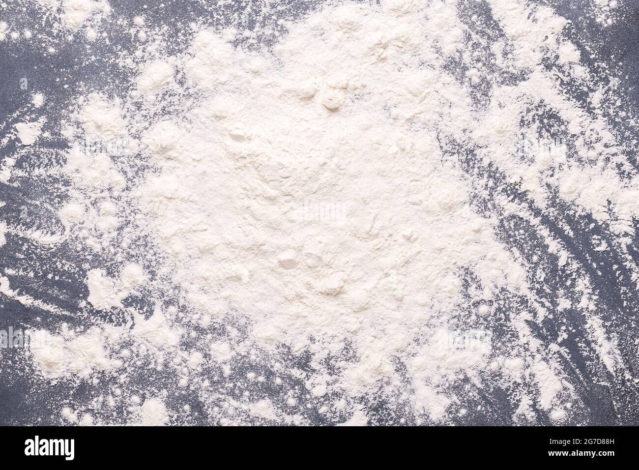 Baking or cooking background, flour on the dark background. Top view ...