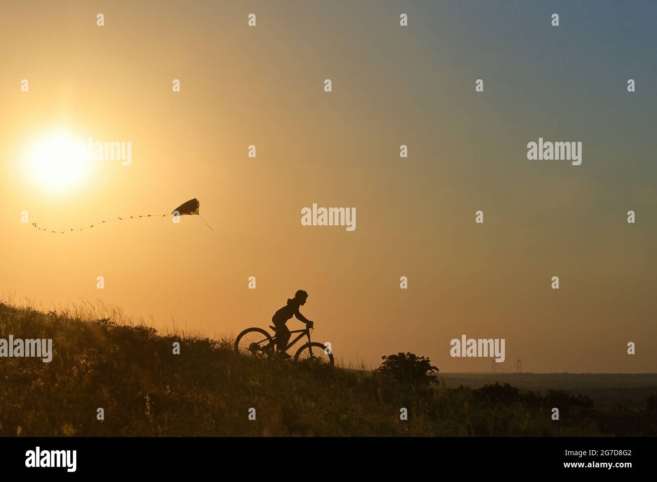 Silhouette Young Boy Playing With His Kite Riding On Bike Stock Photo ...