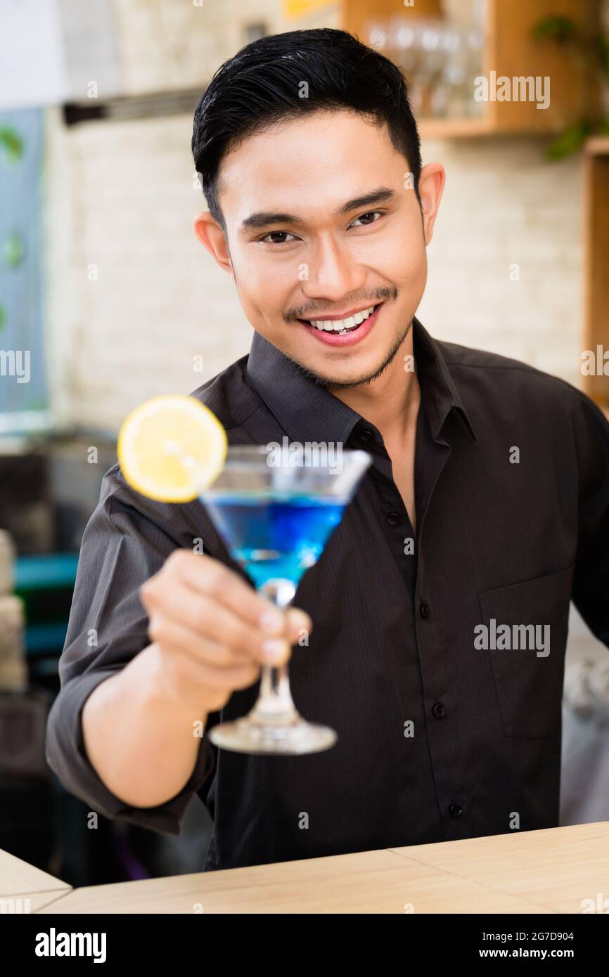 Young man at bar counter holding cocktail hi-res stock photography and ...