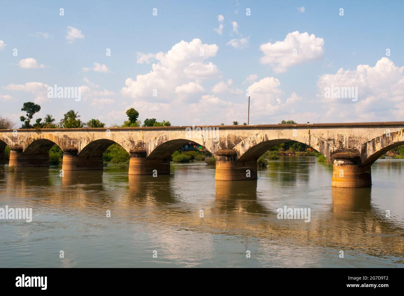French-built bridge across an arm of the Mekong River links Don Det and ...