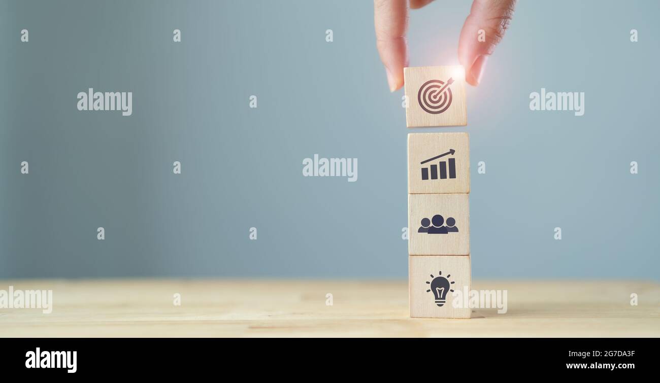 Businessman hand arranging wood block with icon business strategy ...
