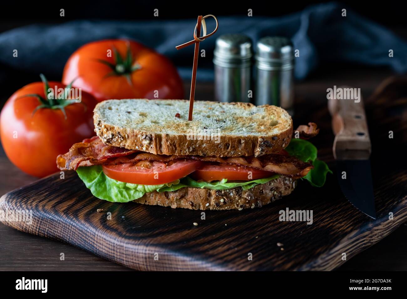 Front facing view of a toasted bacon and tomato sandwich with salt and ...