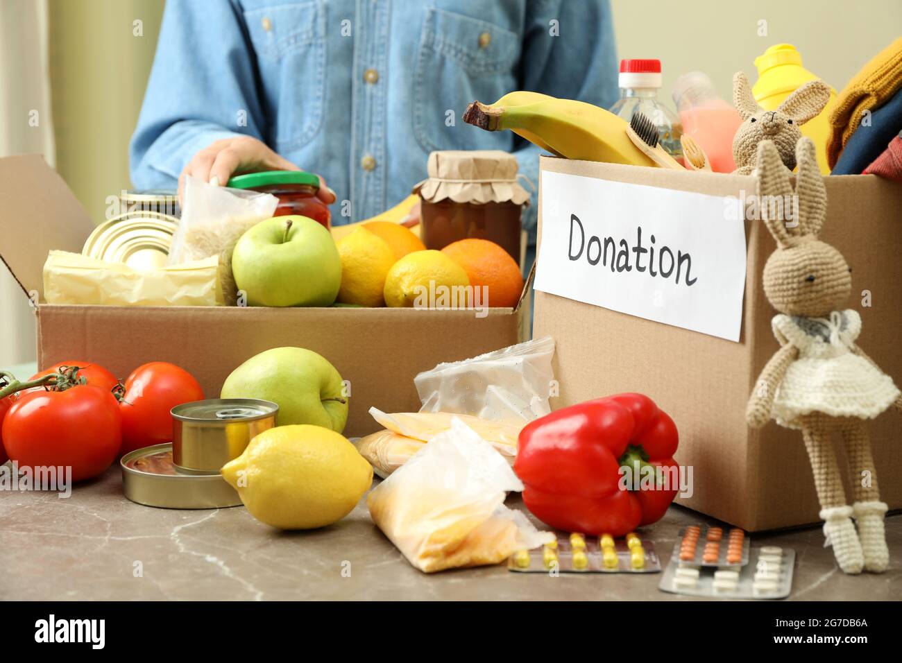 Donation concept with girl and different food Stock Photo - Alamy