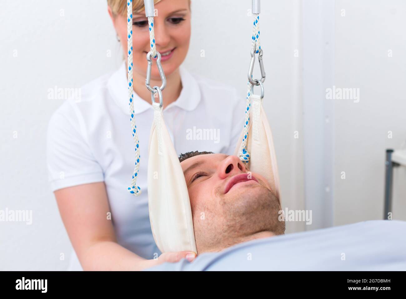 Patient at physiotherapy doing physical exercises with his therapist in ...