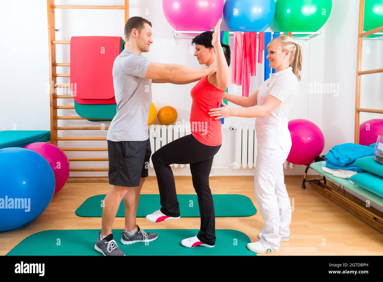 Patients at the physiotherapy doing physical exercises with therapist ...