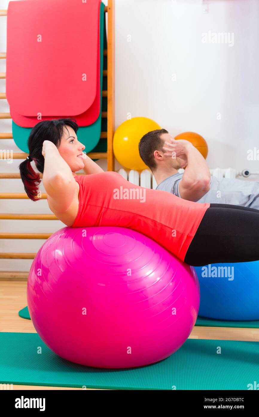 Patients at the physiotherapy doing physical exercises with therapist ...