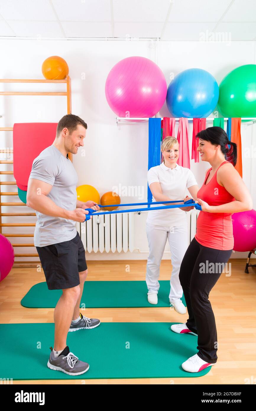 Patients at the physiotherapy doing physical exercises with therapist ...