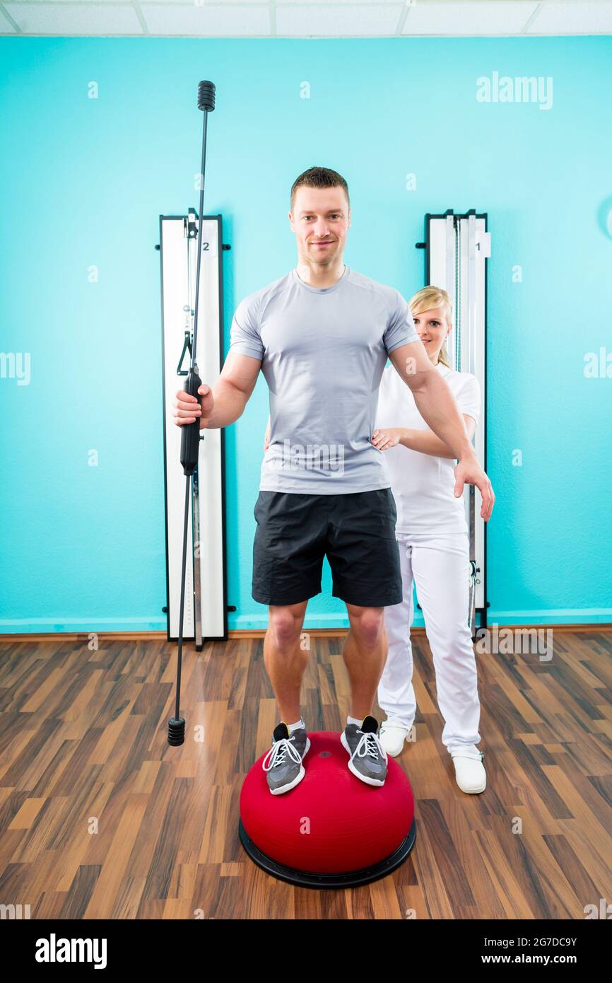 Patient at the physiotherapy doing physical exercises using flexi bar ...