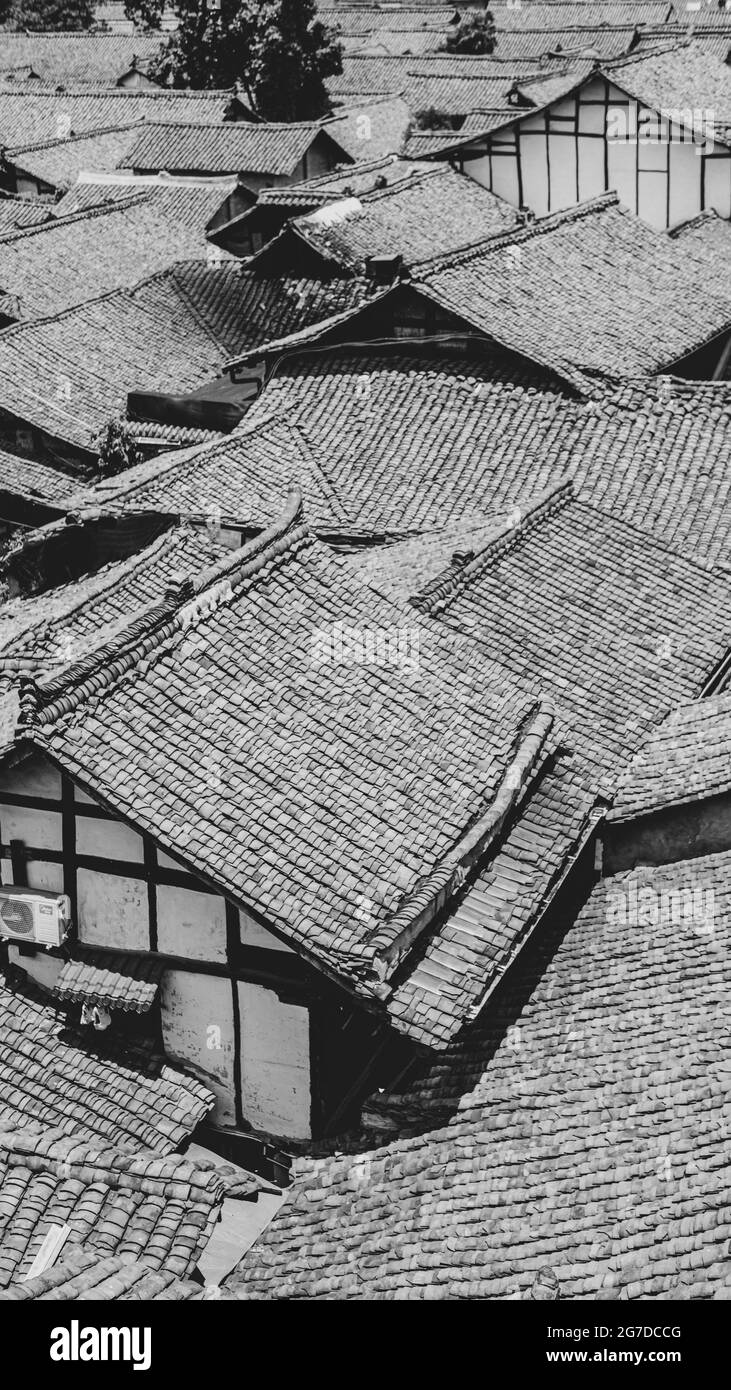 Vertical high angle shot of the identical roofs of small houses in a ...