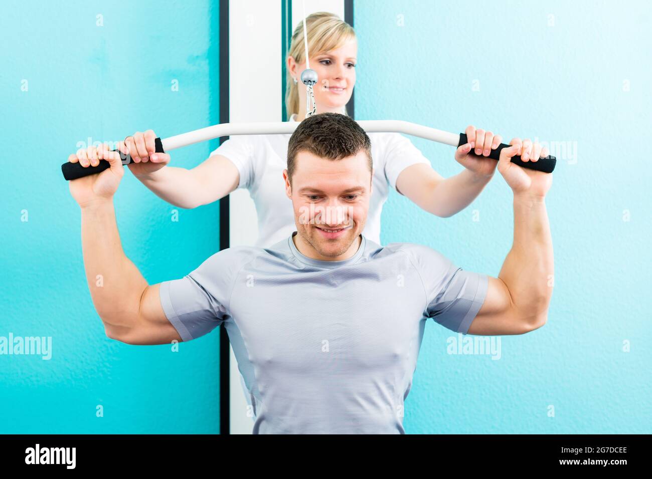 Patient at the physiotherapy doing physical exercises with therapist in ...