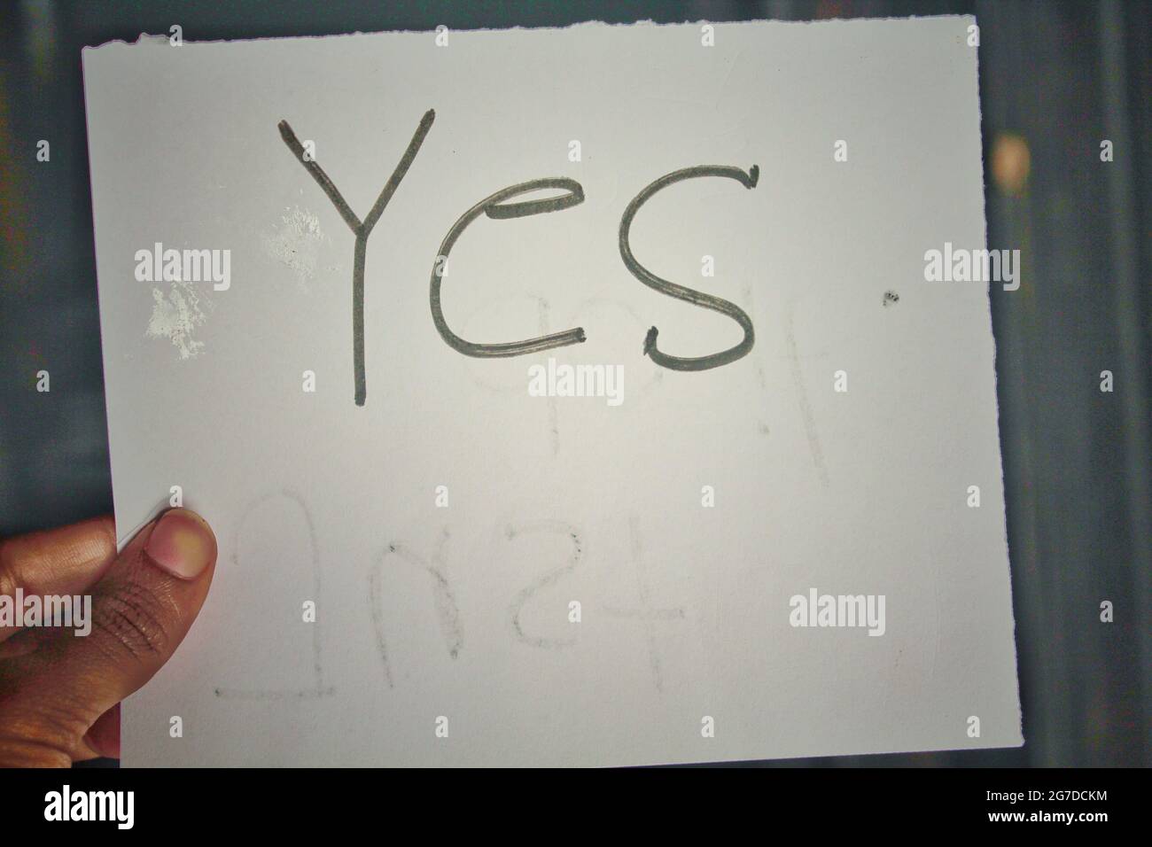 'Yes' motivational word written on paper Stock Photo - Alamy