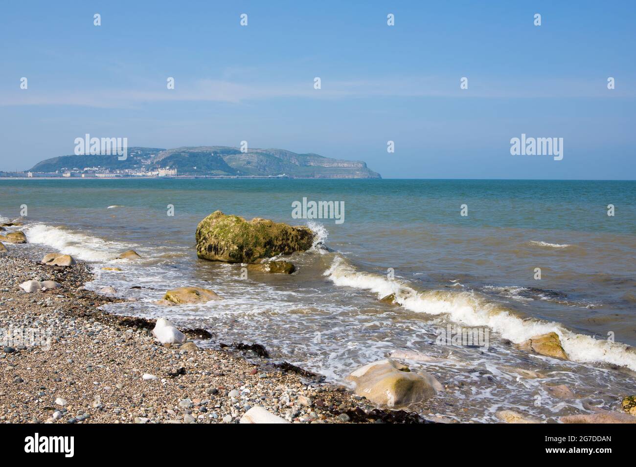Wave splashing on the rocks at the base of the little Orme, Llandudno ...
