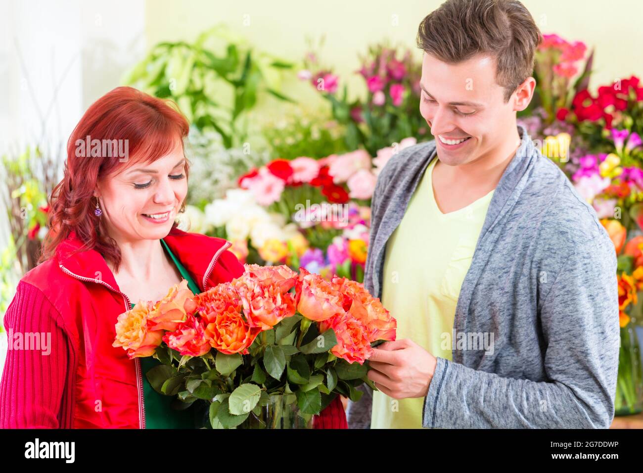 Female florist selling man flowers in flower shop Stock Photo - Alamy