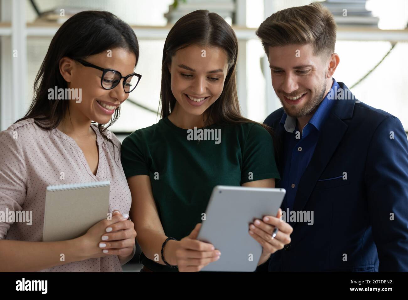 Man woman employees look tablet hi-res stock photography and images - Alamy