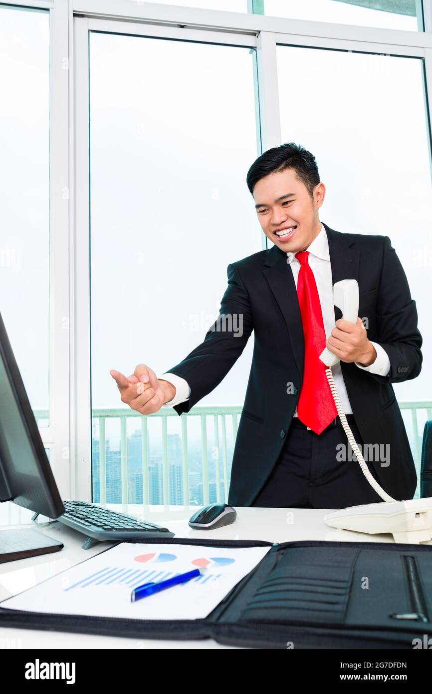 Asian business man telephoning in office controlling profit Stock Photo ...