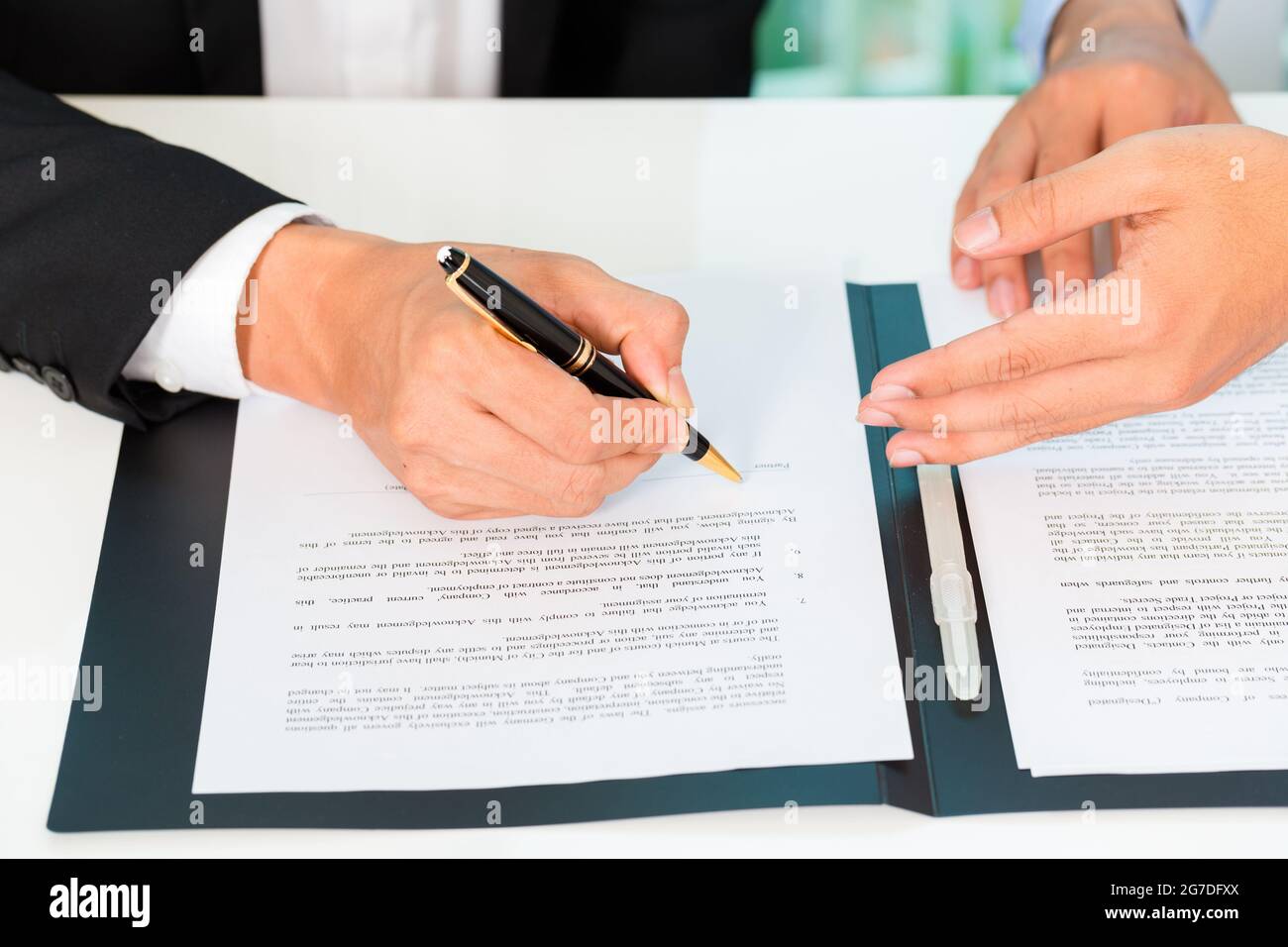 Business people signing agreement in office Stock Photo - Alamy