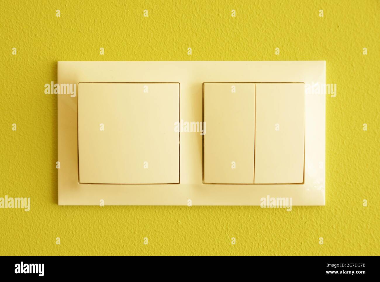 Closeup of white switches on a green wall Stock Photo - Alamy