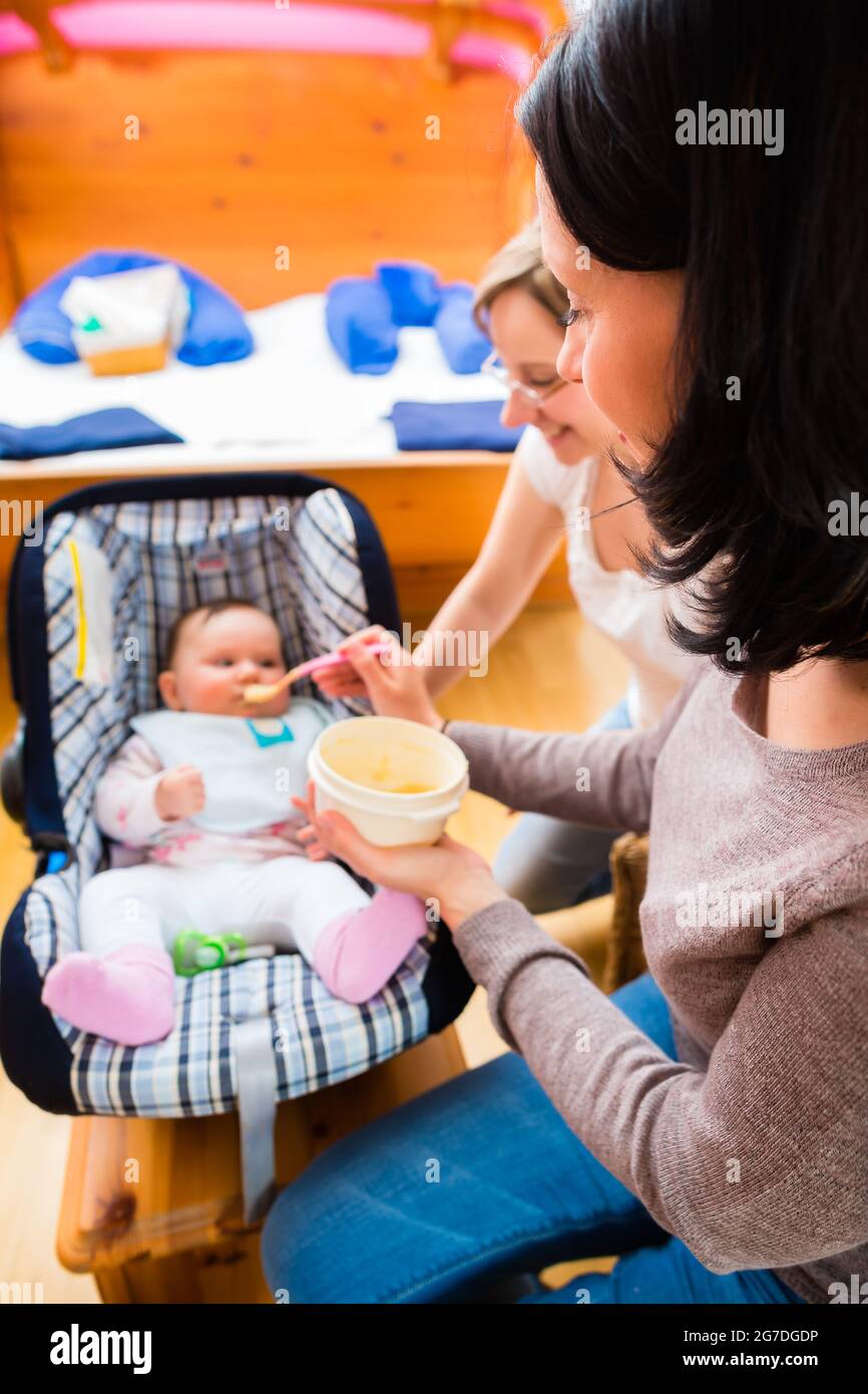 Mother feeding baby at midwife practice Stock Photo - Alamy