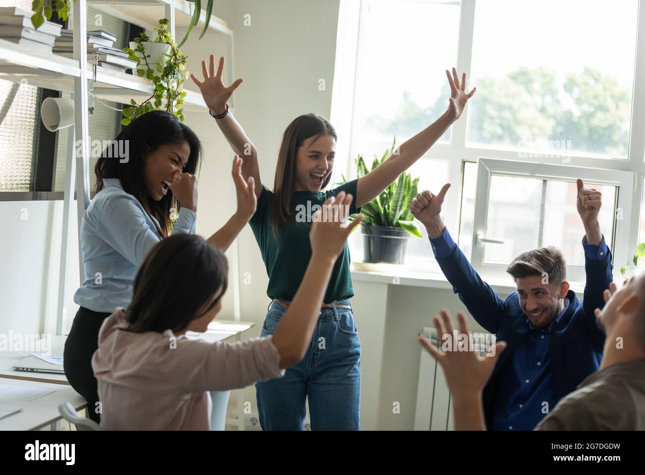 Happy team proud of good job result, meeting in office Stock Photo - Alamy