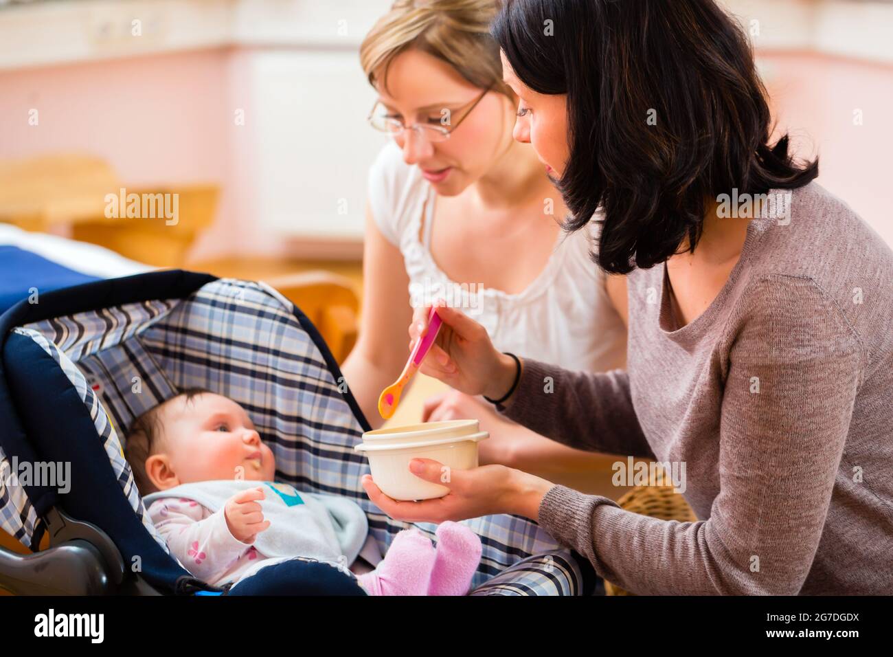 Mother feeding her baby at midwife practice Stock Photo - Alamy
