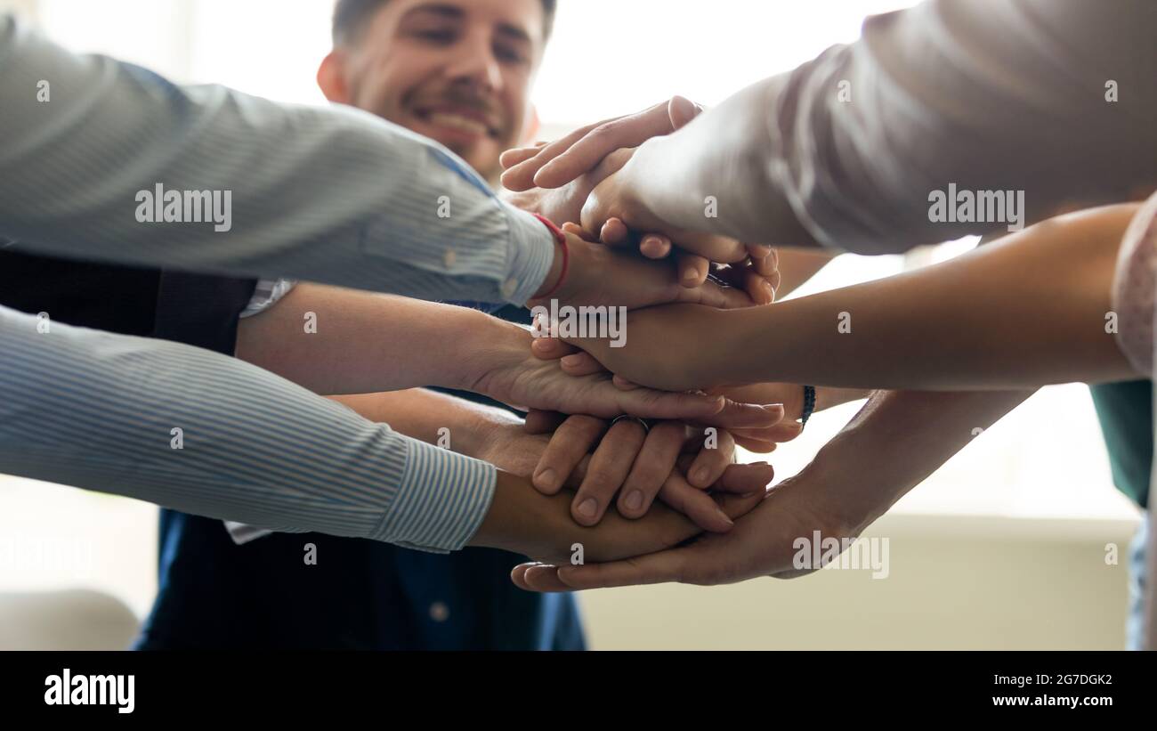 Business team members, millennial office employees putting hands ...