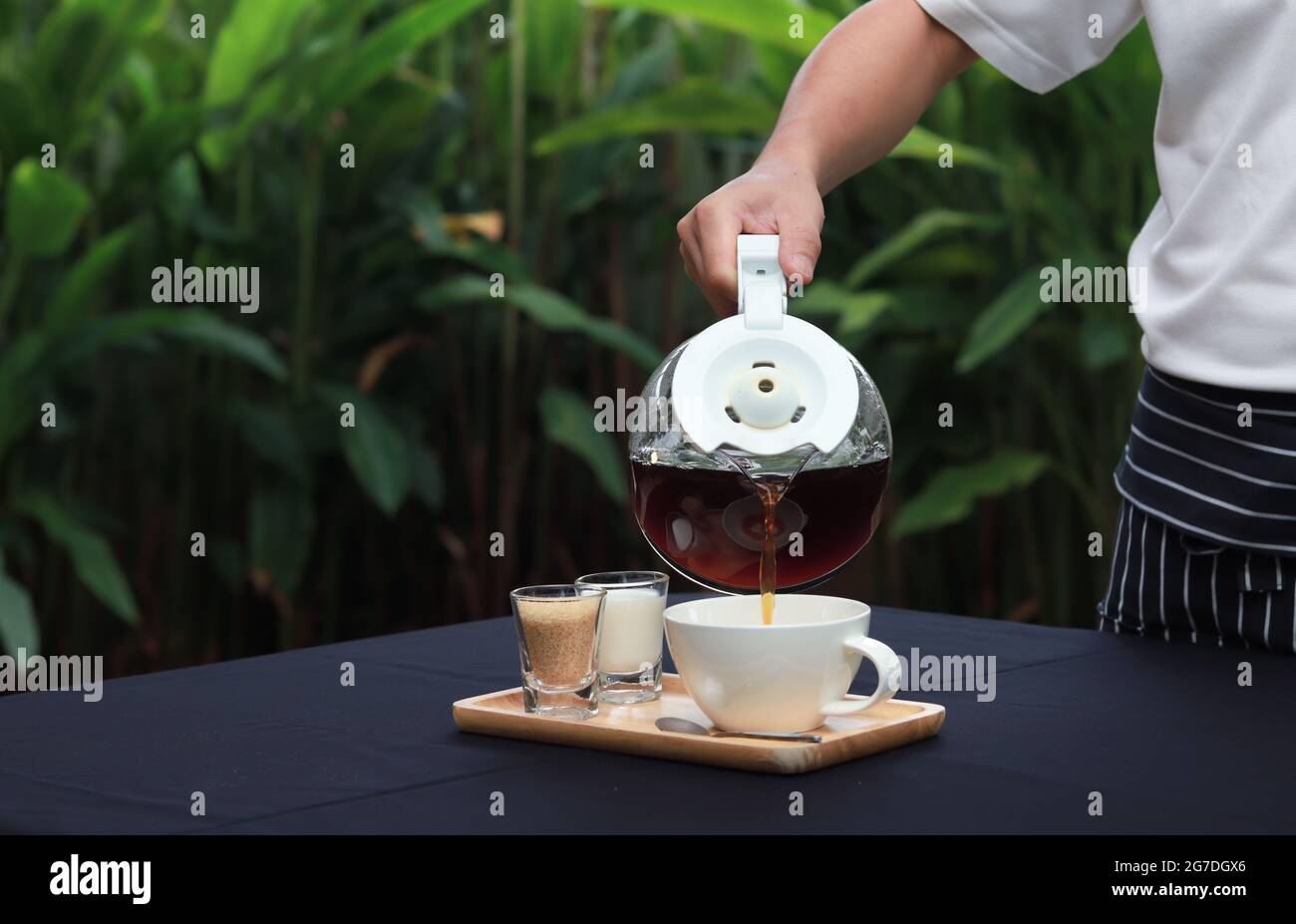 Waiter pouring coffee hi-res stock photography and images - Alamy