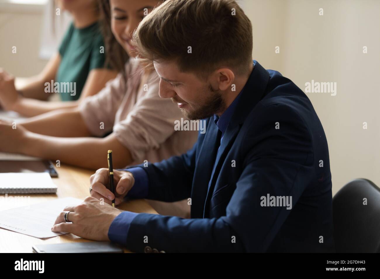 Intern, office employee writing notes on corporate training Stock Photo ...