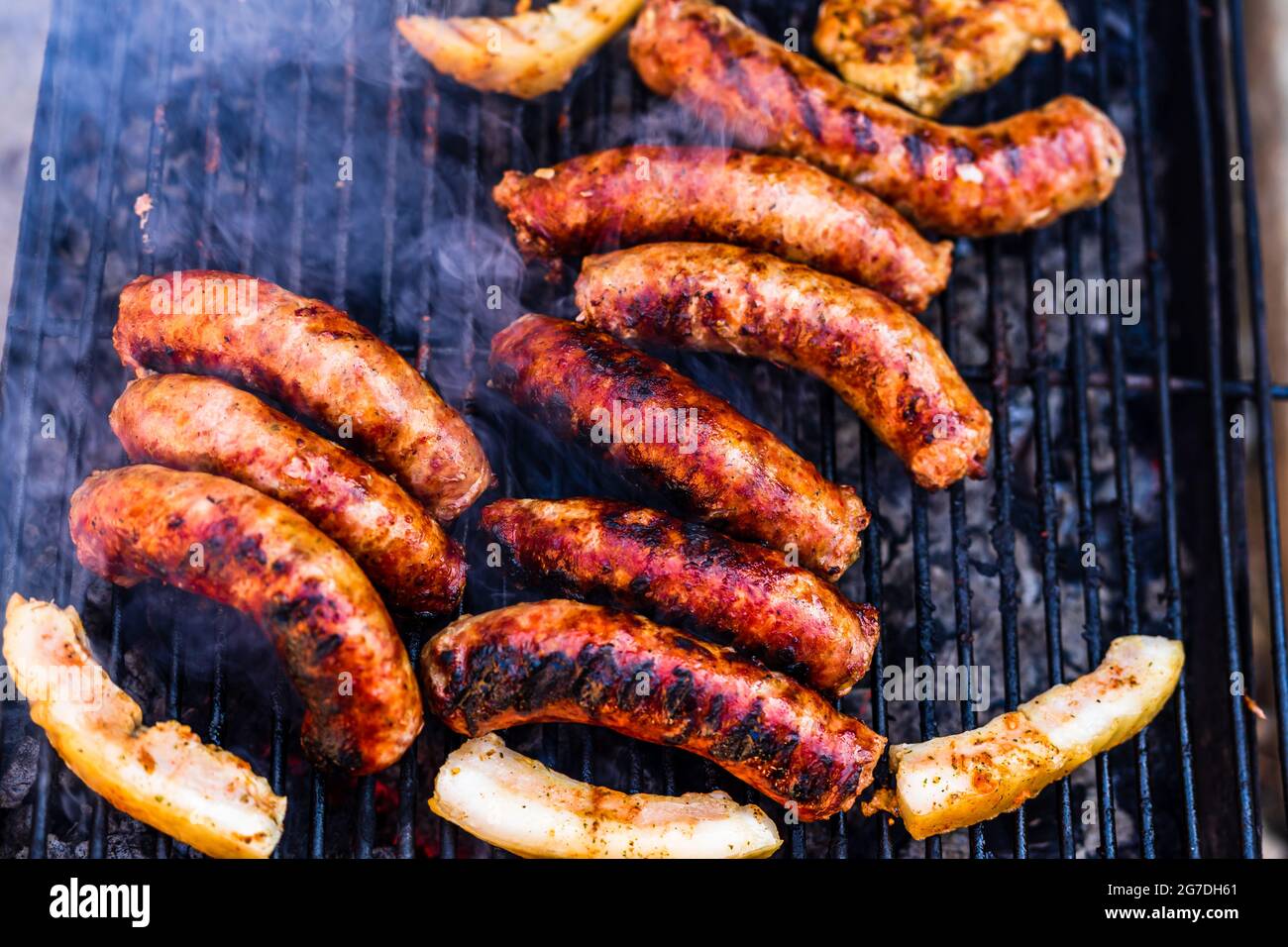 Sausages grilling on the barbecue grill Stock Photo - Alamy