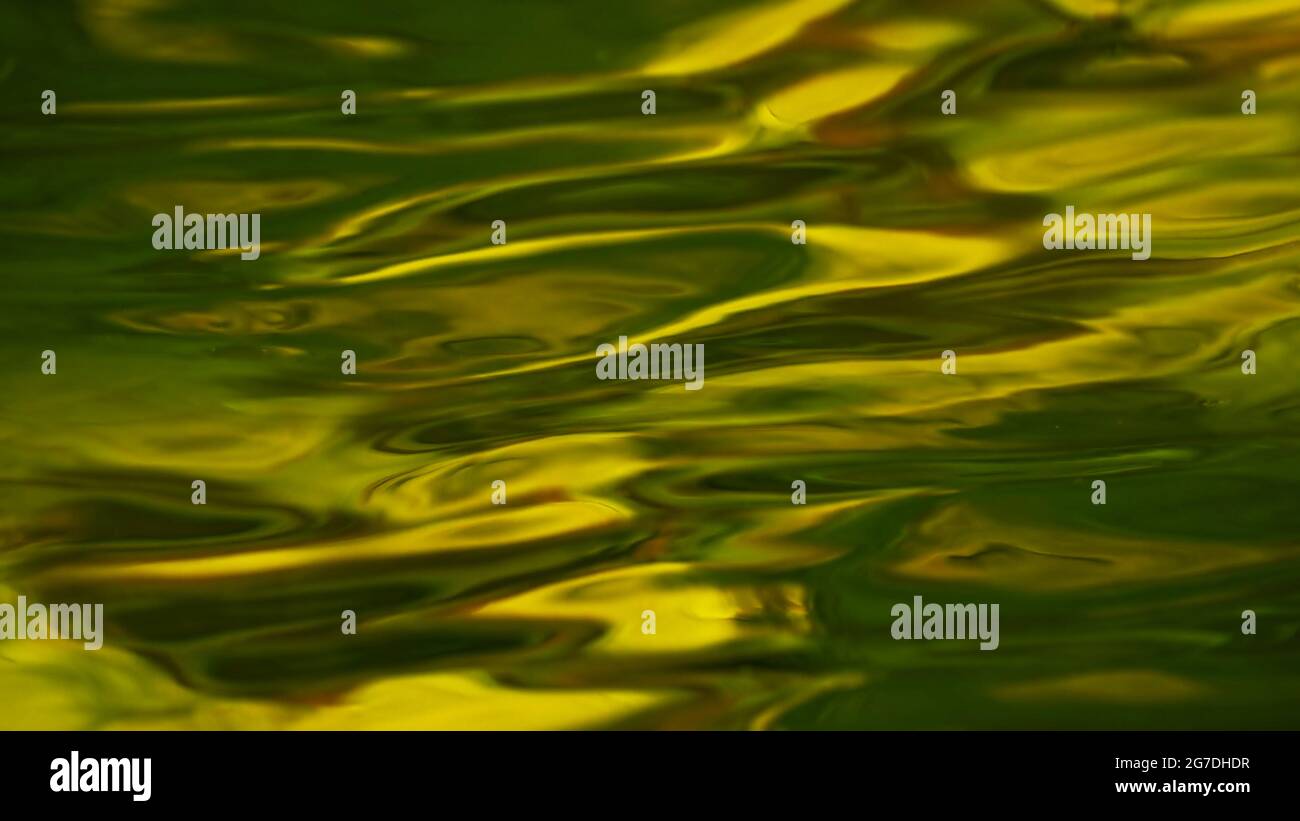 3D rendering of a bright abstract colored liquid metal alloy spreading ...