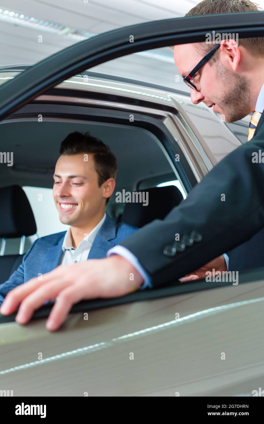 Customer buying new car in auto dealership Stock Photo - Alamy