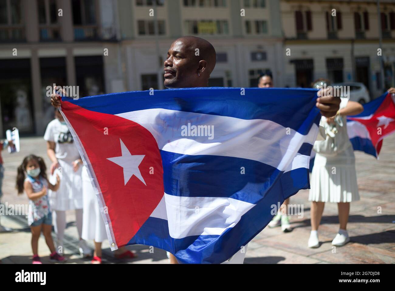 A man seen holding a Cuban flag as he takes part in a protest in ...