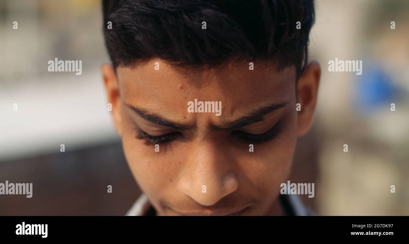 Indian kid face looking down hi-res stock photography and images - Alamy
