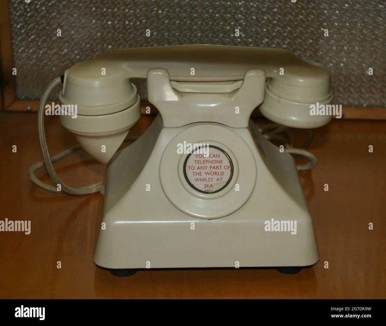 Old vintage telephone with a saying 'you can telephone to any part of ...